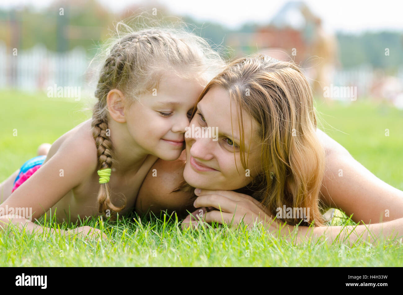 Five-year cute daughter pressed her face to the mother's face on a ...