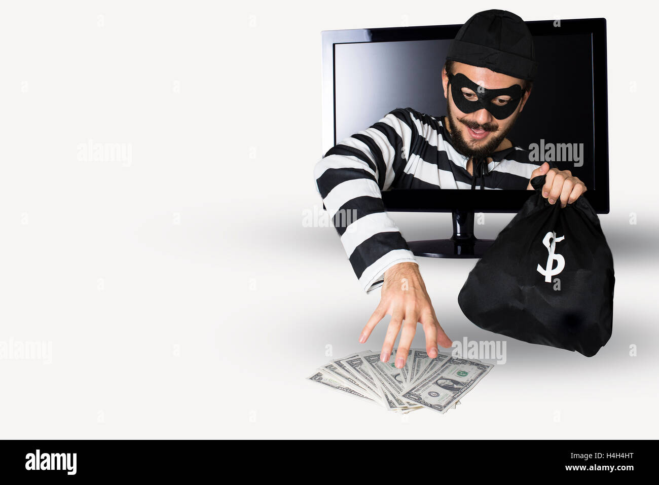 Happy Burglar stealing money in a computer monitor on a white ...