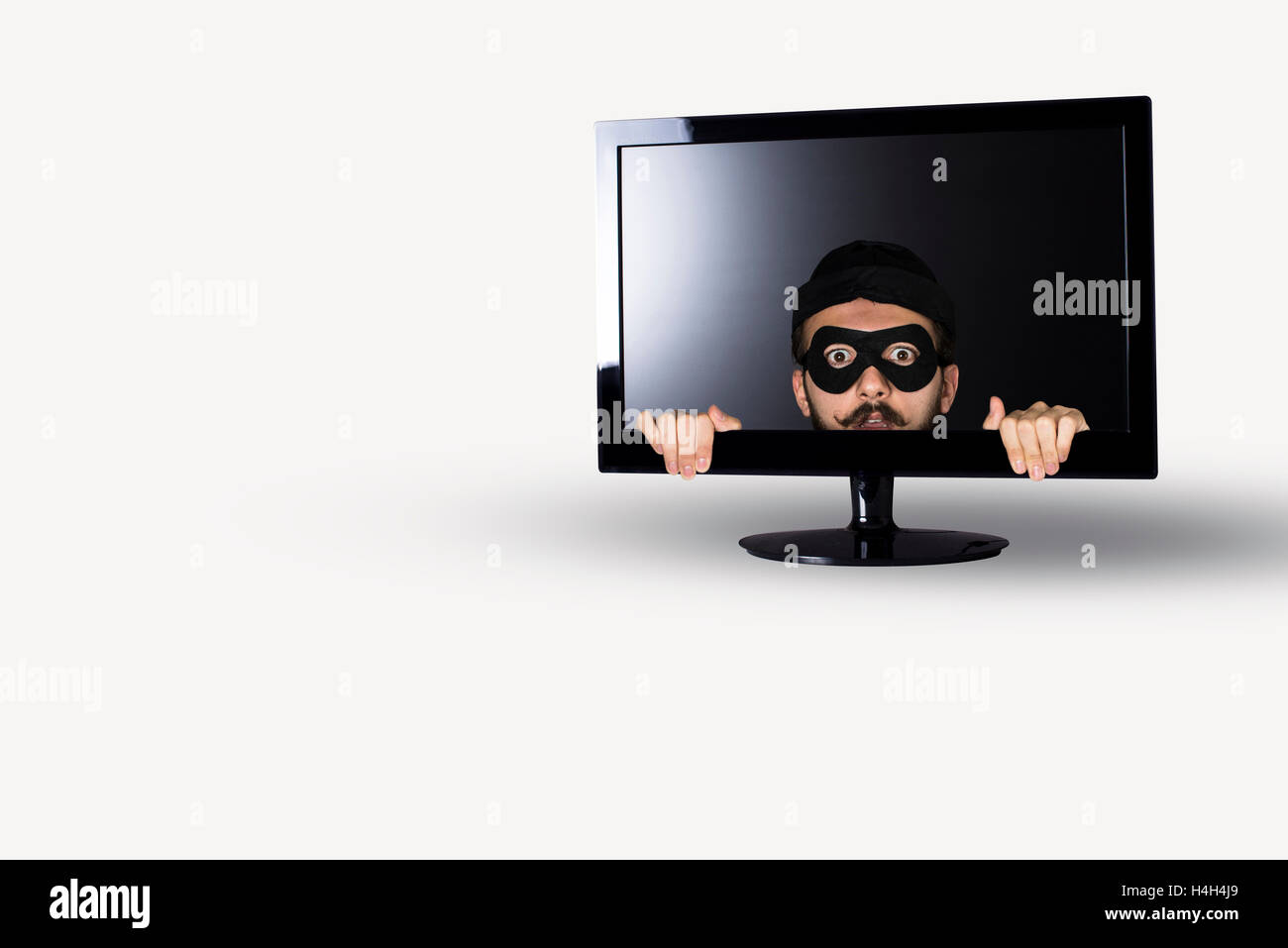 Shocked Burglar in a computer monitor on a white background Stock Photo ...
