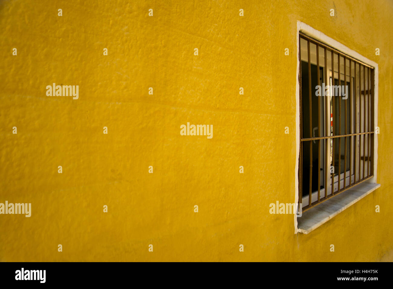 A window on the yellow wall Stock Photo - Alamy