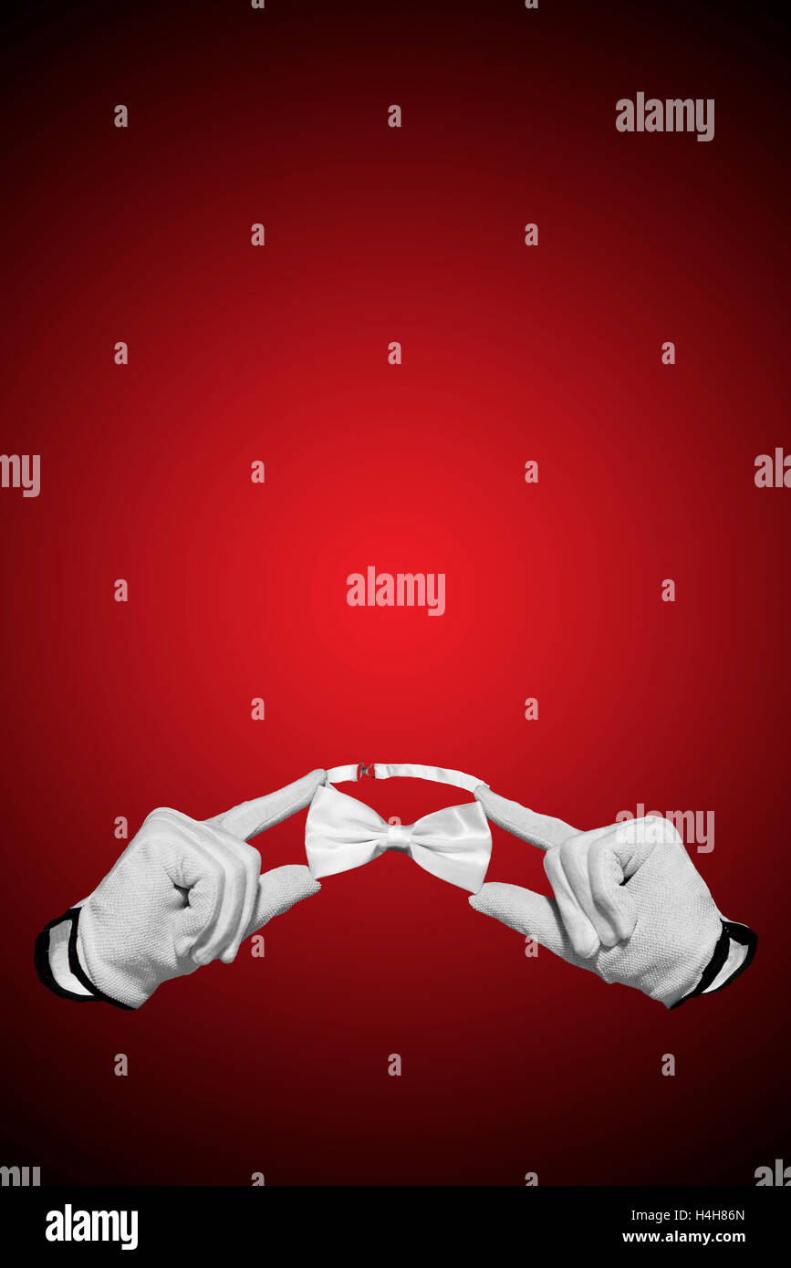 Invisible man figure is posing with white bow tie and gloves on a red ...