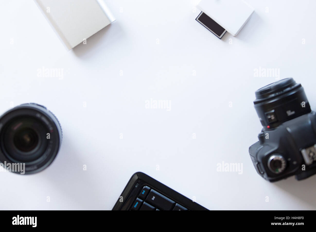 White desk with a professional camera and accessoires Stock Photo - Alamy