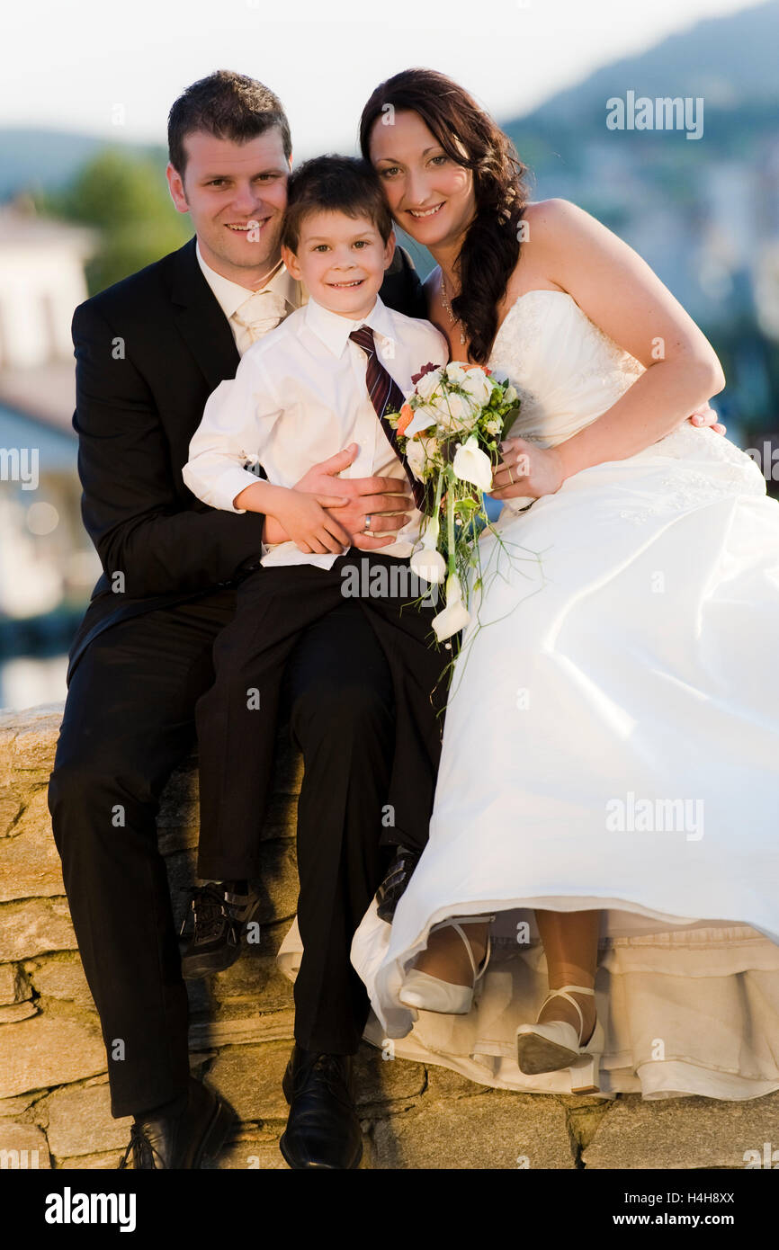 Bridal couple and a boy Stock Photo - Alamy