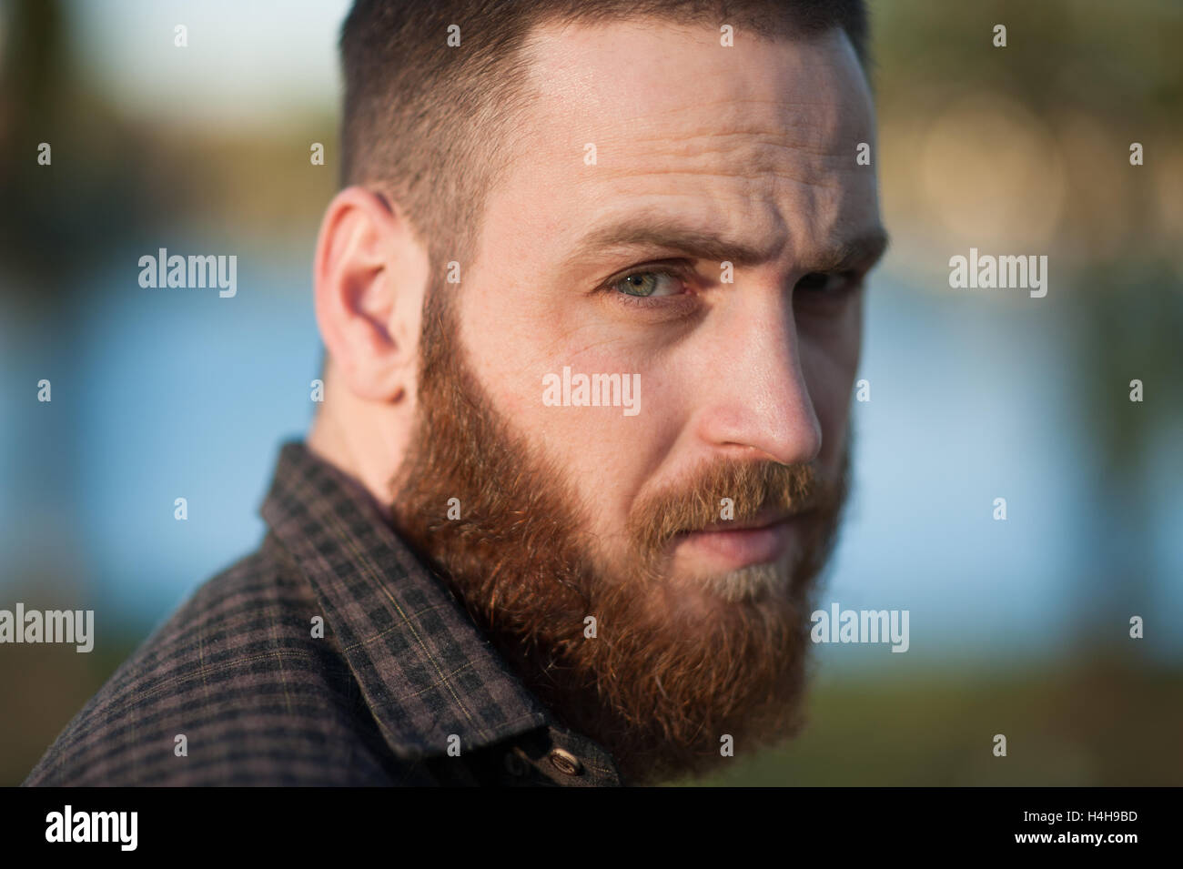 portrait of a serious bearded young men outdoors Stock Photo - Alamy