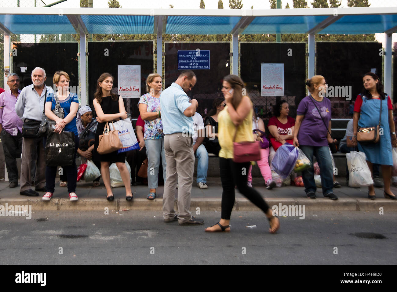 Crowded people in the bus station. They are waiting for thebus and ...