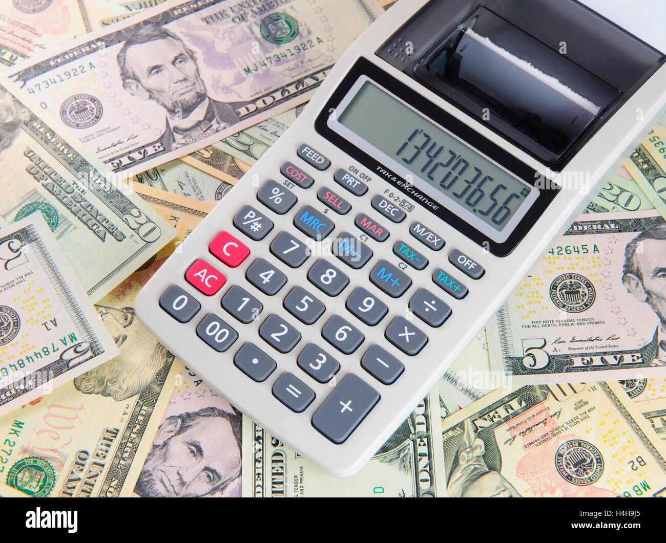 Calculator and dollars Stock Photo - Alamy