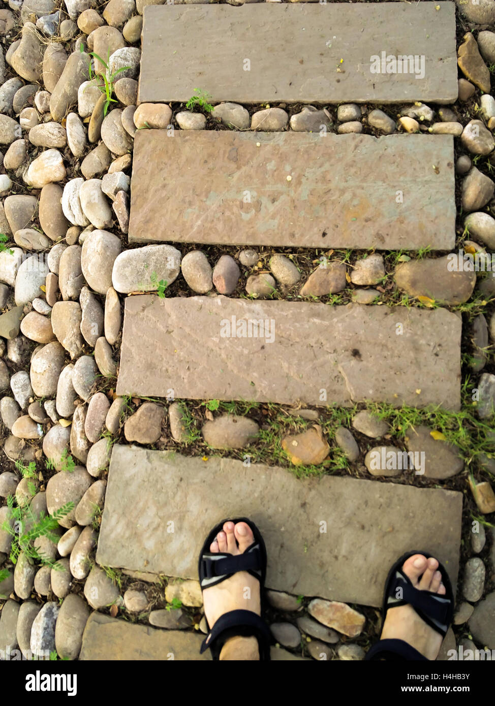 Man walking on a stone path Stock Photo - Alamy