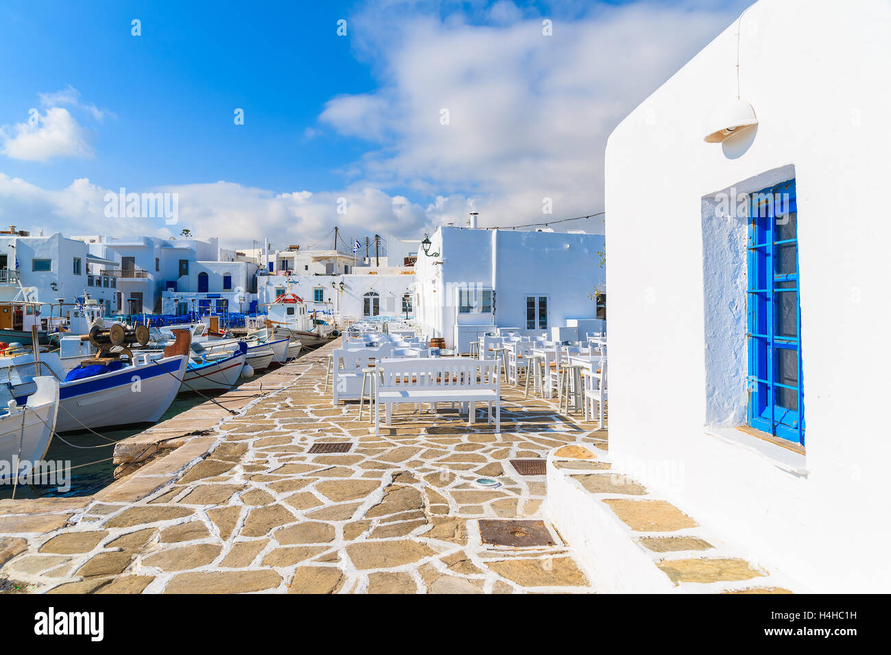 A view of Naoussa port with fishing boats and taverna buildings, Paros ...