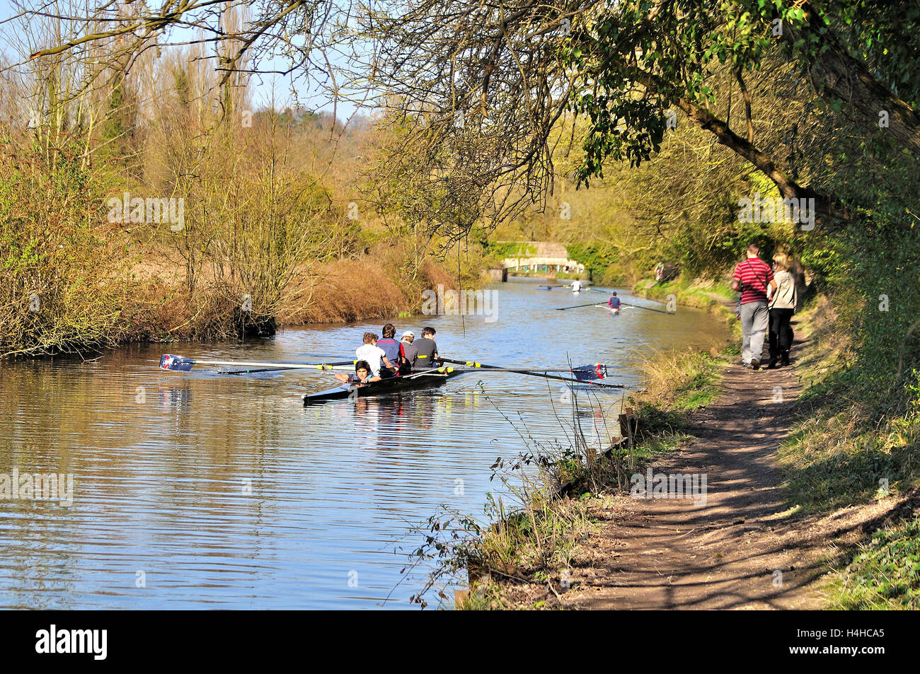 People walking along along river Itchen Navigation Walk next to ...
