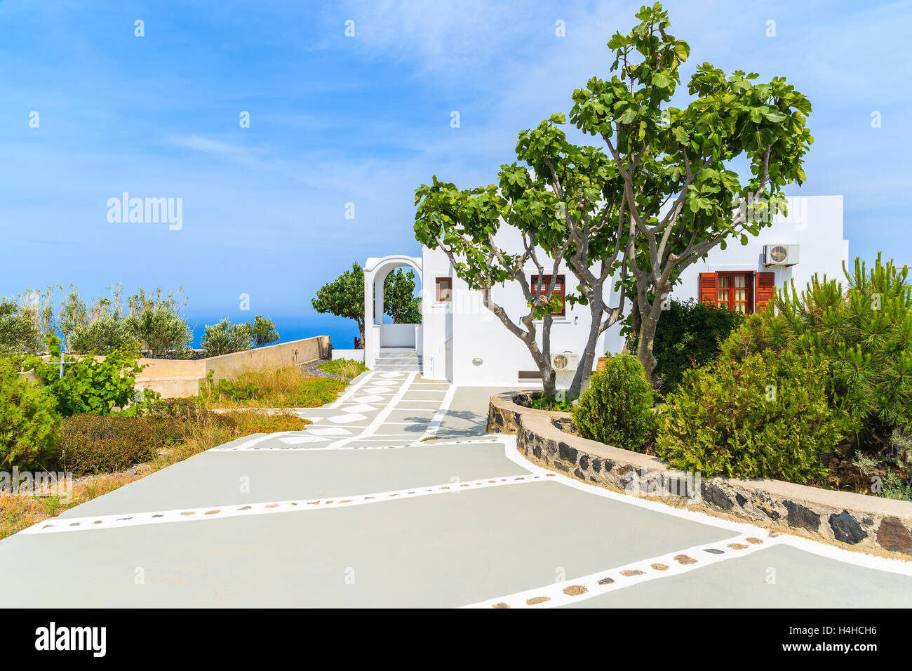 A typical white house in green rural landscape of Imerovigli village on ...