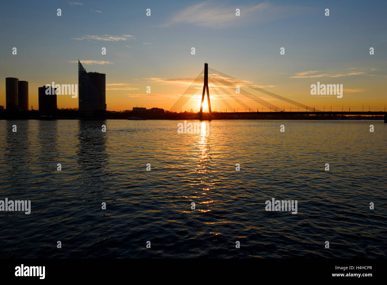 Riga suspension bridge's silhouette at sunset Stock Photo - Alamy