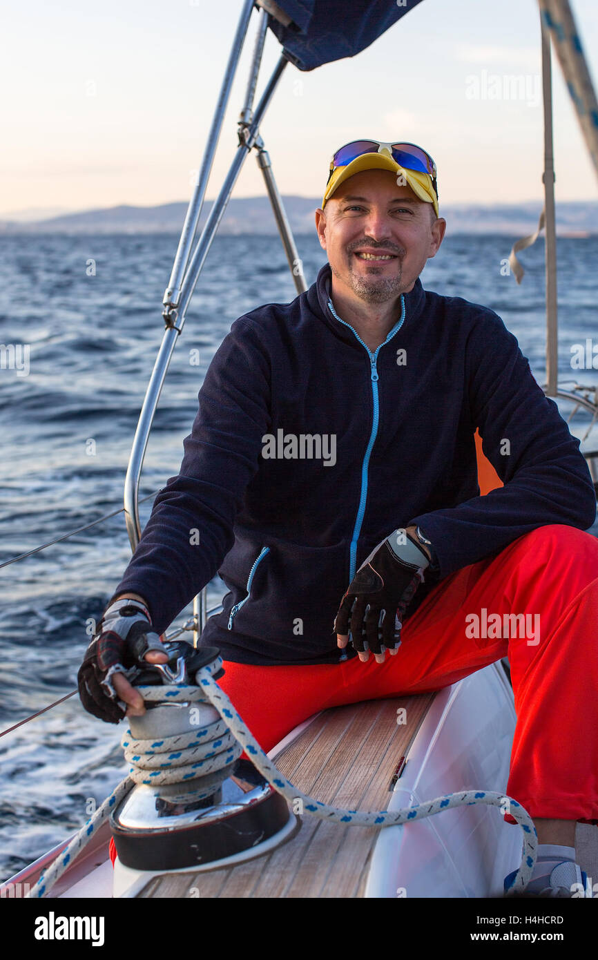 Portrait of man sits on his sail yacht Stock Photo - Alamy