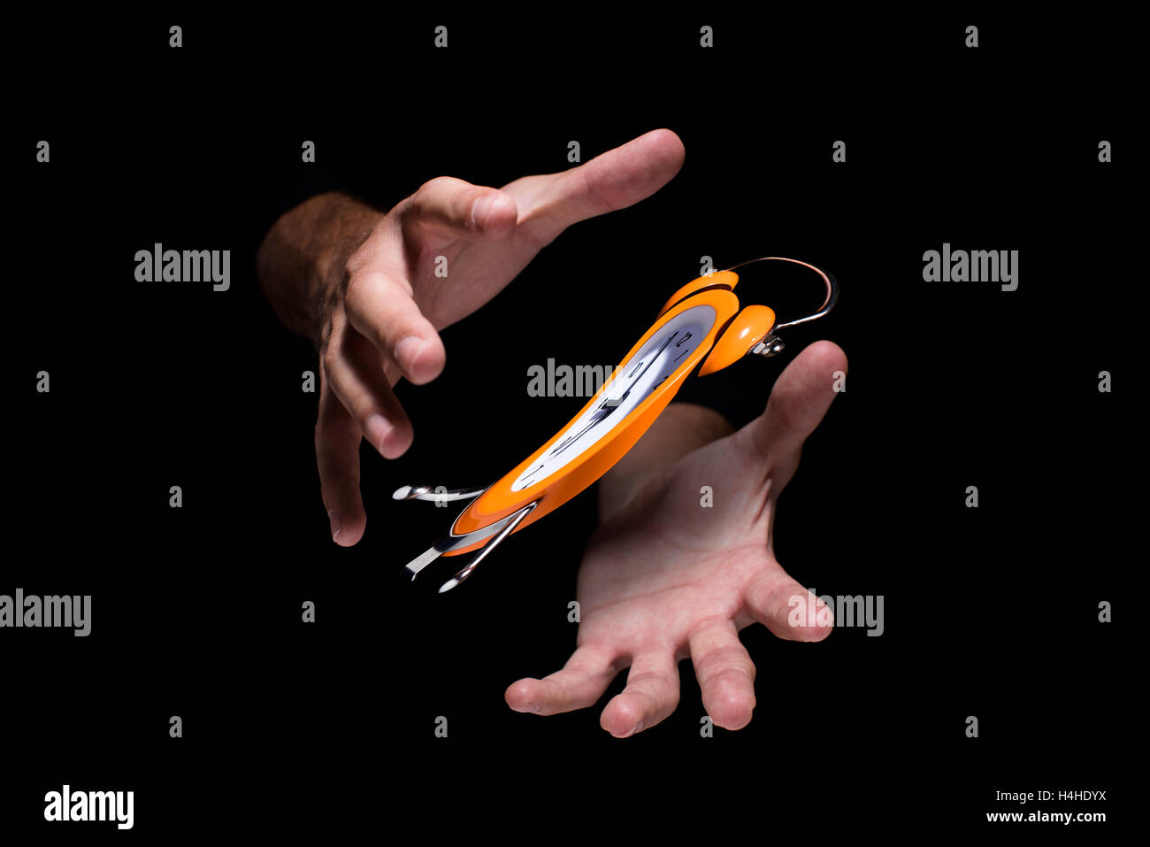 Floating clock between the humans hands.Streched clock in time and ...