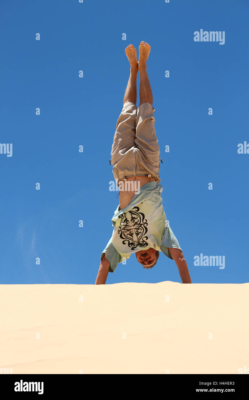 Man in standhand on dune slope Stock Photo - Alamy
