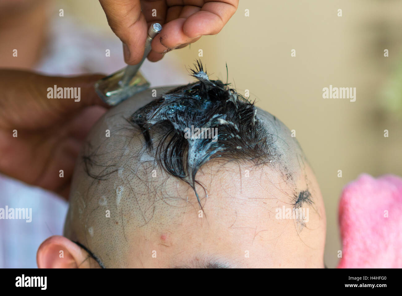 knife cutting hair at the ordination ceremony of a Buddhist monk in ...