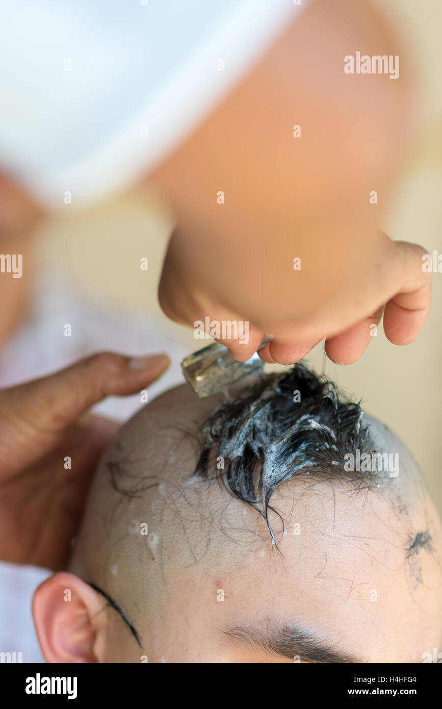 knife cutting hair at the ordination ceremony of a Buddhist monk in ...