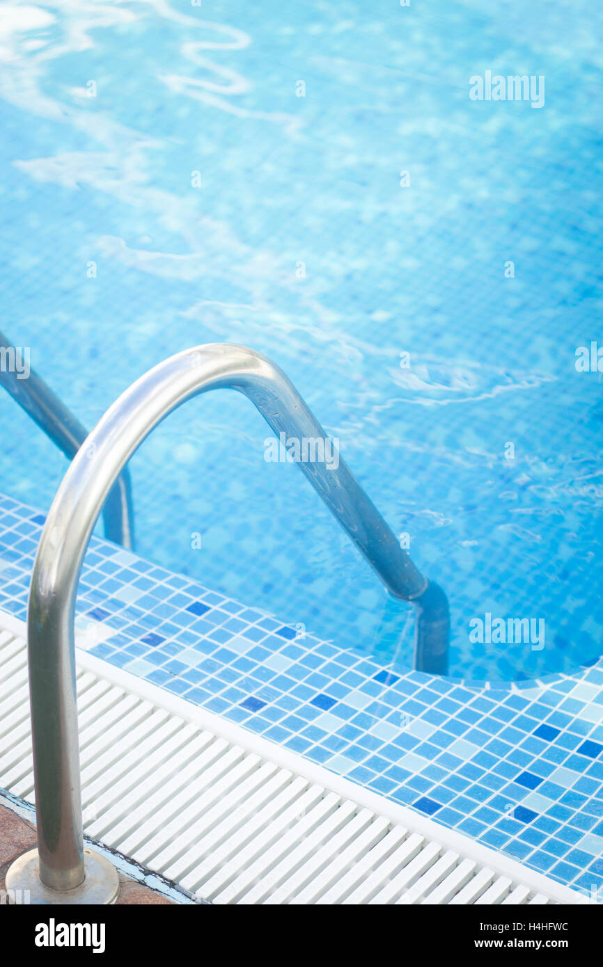 Outdoor swimming pool water on hot summer's day in luxury hotel resort ...