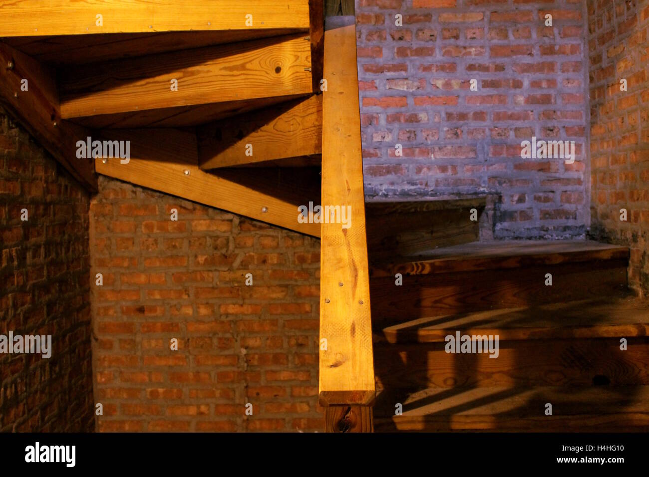 An old wooden staircase behind a brick apartment building Stock Photo ...