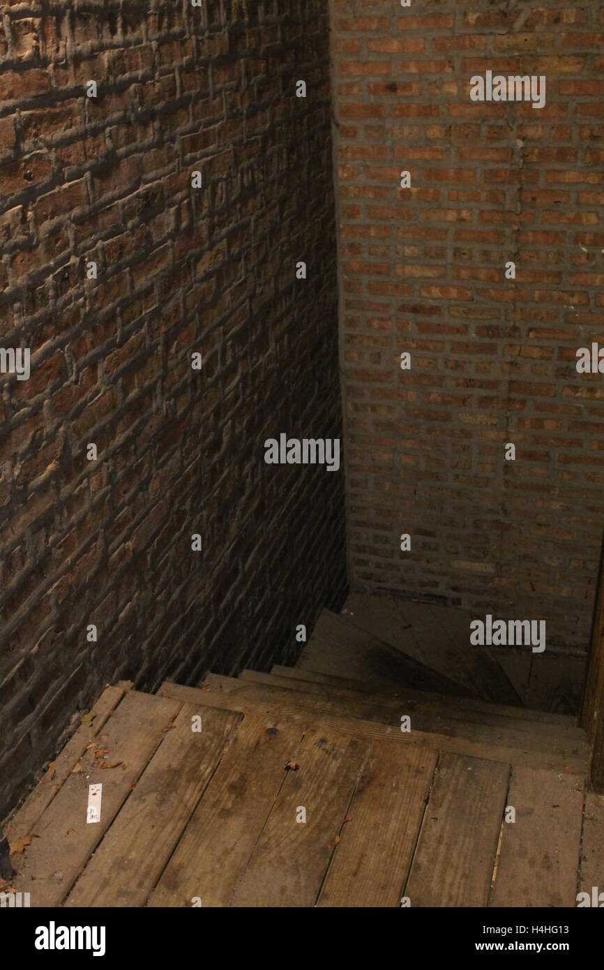An old wooden staircase behind a brick apartment building Stock Photo ...