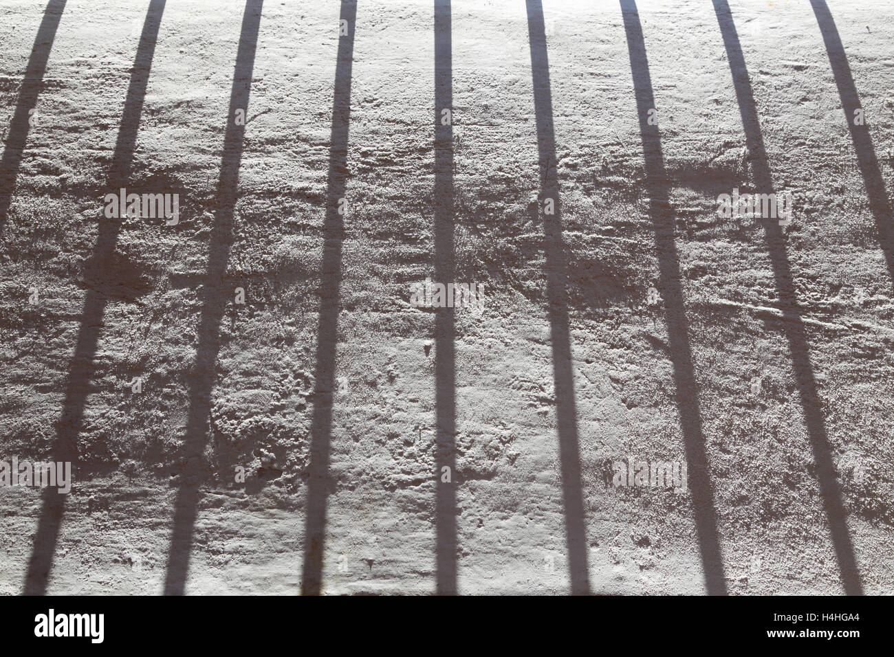 shadow vertical window grille casted on textured whitewashed surface ...