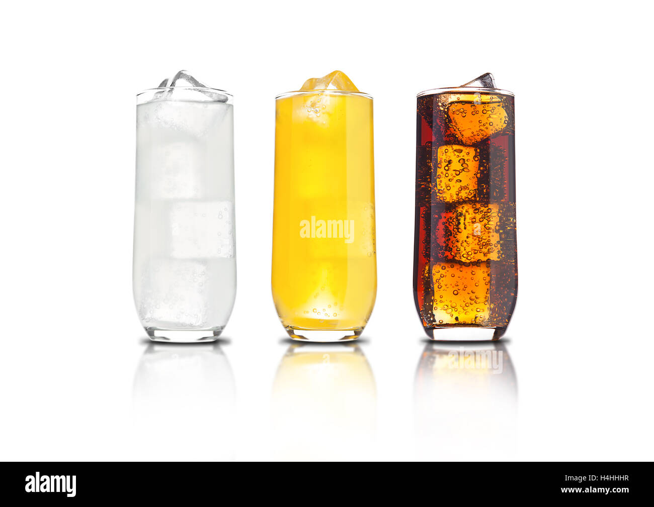 Glasses of orange soda, cola and lemonade with ice cubes and bubbles with reflection on white ...