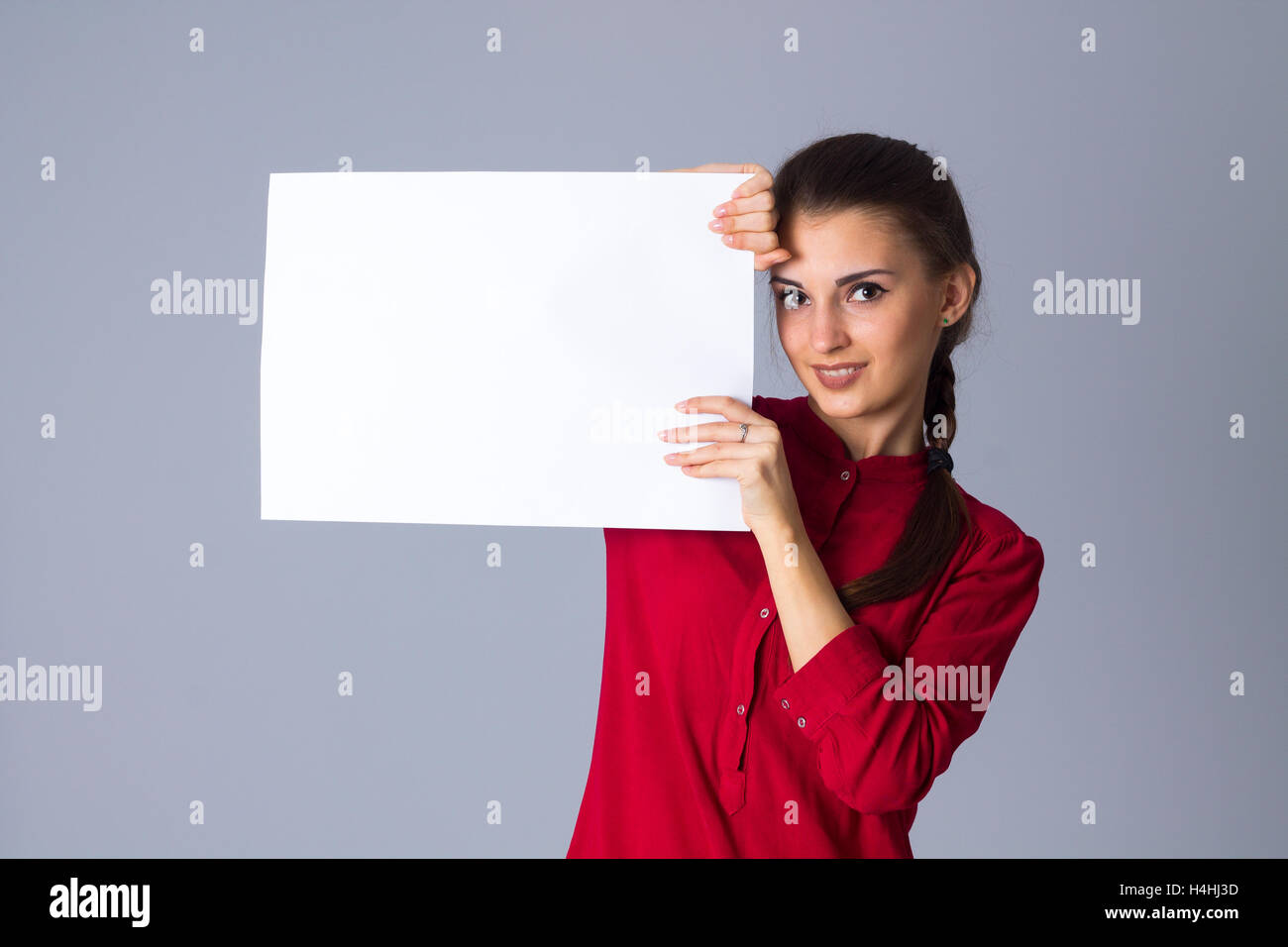 Woman holding white sheet of paper Stock Photo - Alamy