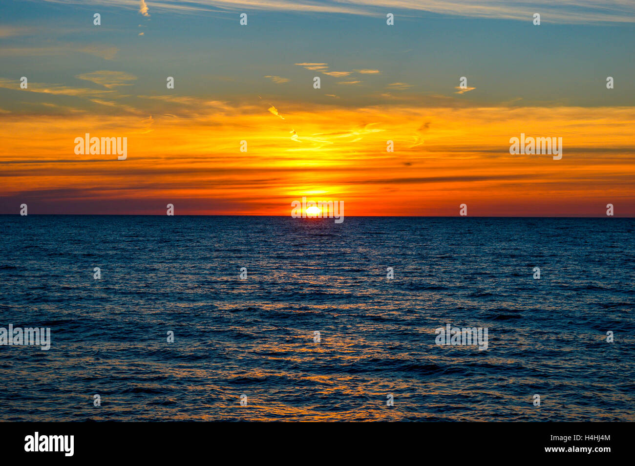 Brilliant sunrise on the waters of Lake Huron at the pier in Oscoda ...