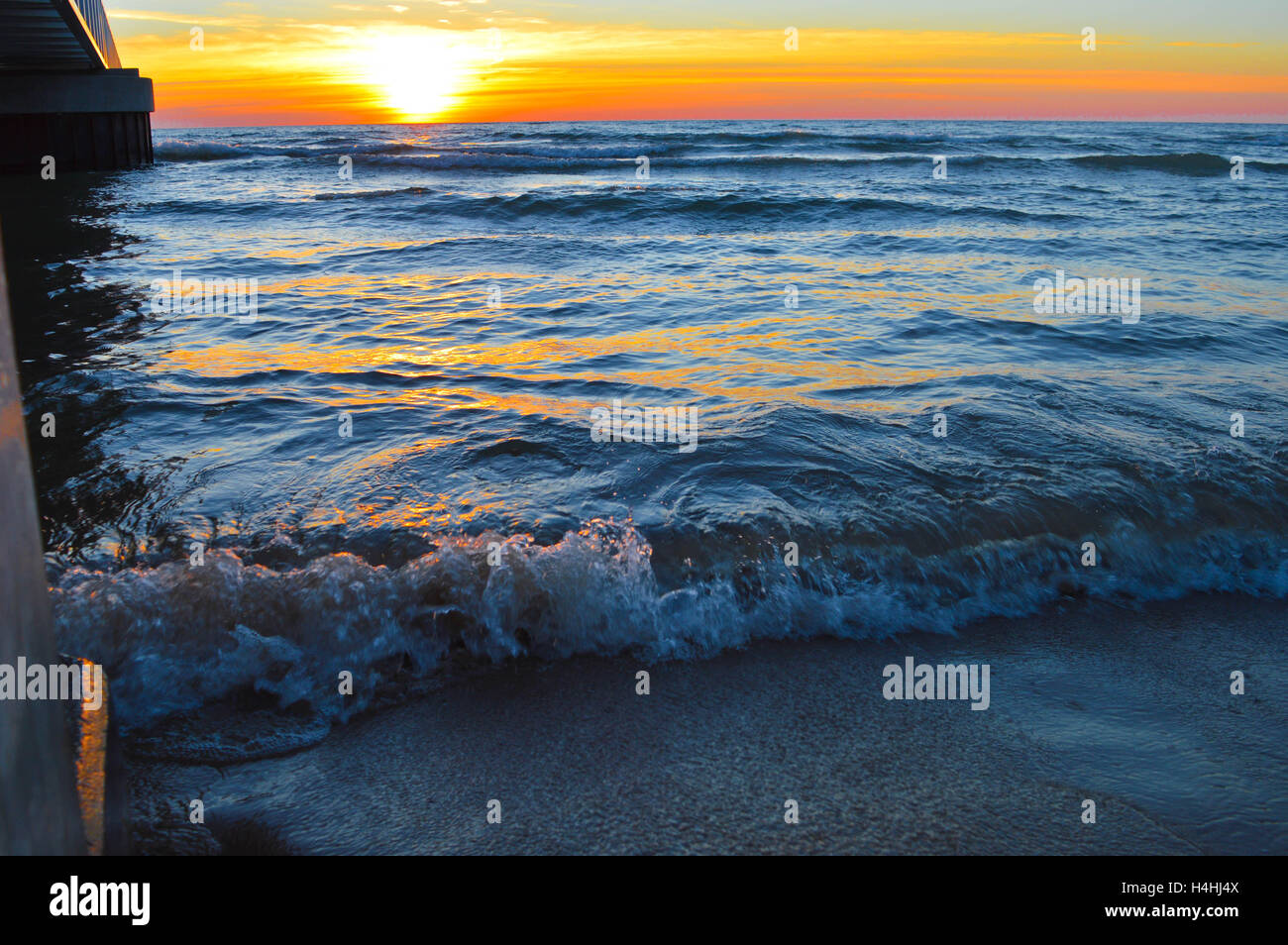 Brilliant sunrise on the waters of Lake Huron at the pier in Oscoda ...