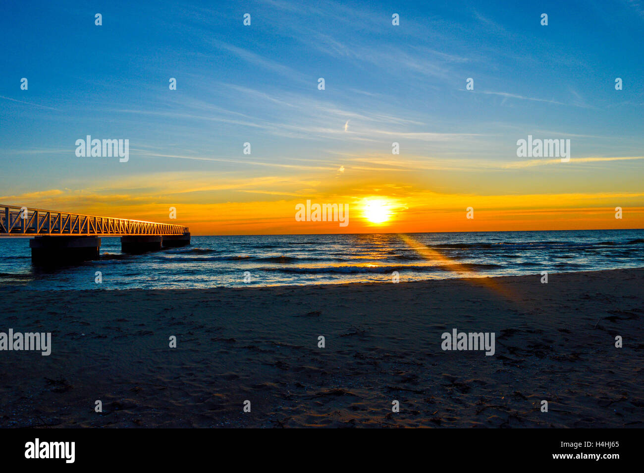 Brilliant sunrise on the waters of Lake Huron at the pier in Oscoda ...