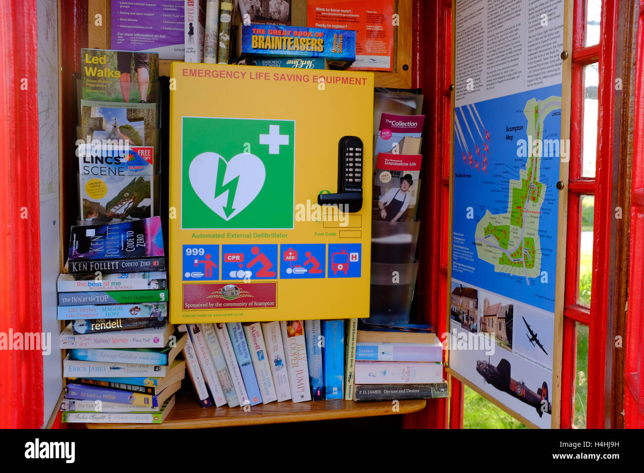 Red phone box re-purposed to house a defibrillator Stock Photo - Alamy