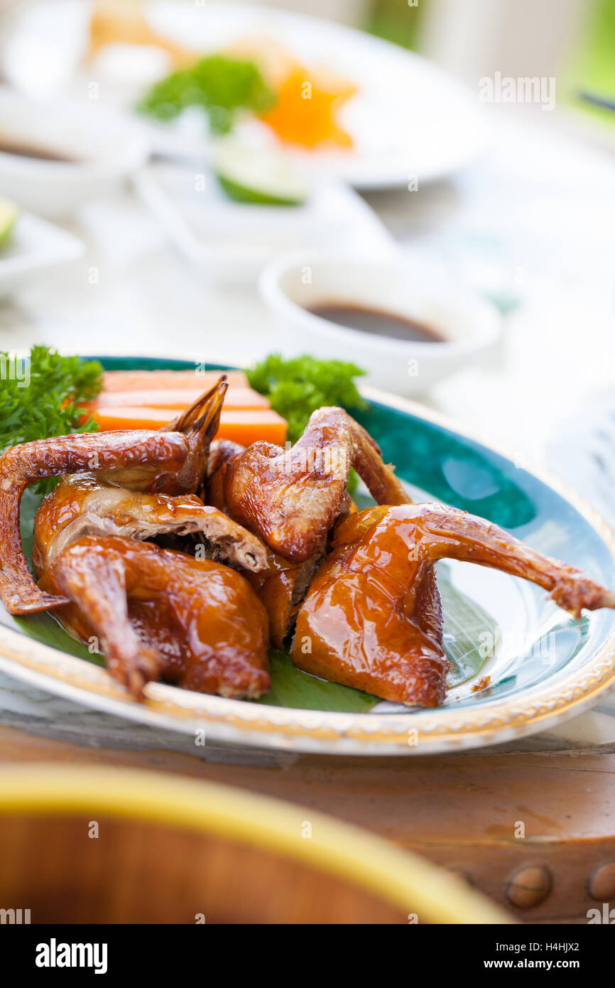A dish of Nice oily brown color of Fried pigeon put on a nice decorated ...