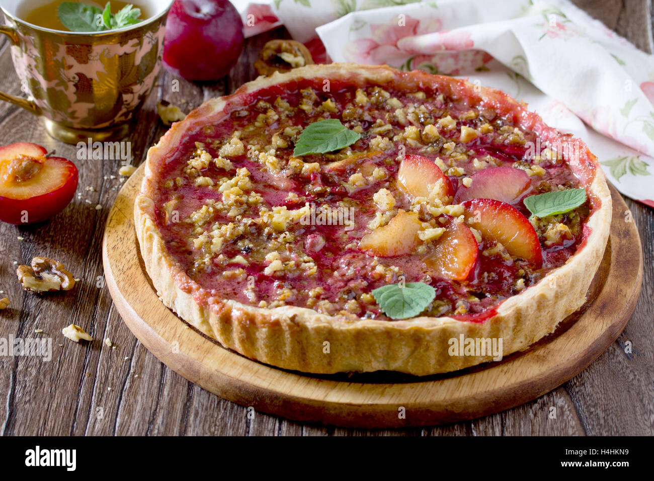 Plum cake shortbread dough with walnuts on a wooden table, selective ...