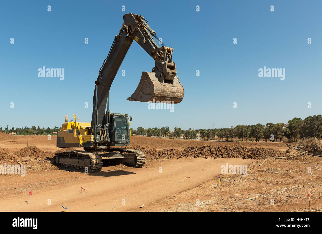 Large tracked excavator on sky background Stock Photo - Alamy