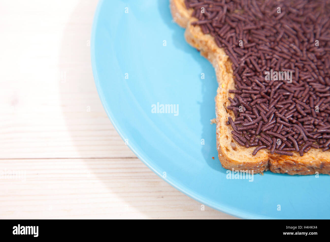 Typical Dutch bread with chocolate hagelslag on wooden background Stock ...
