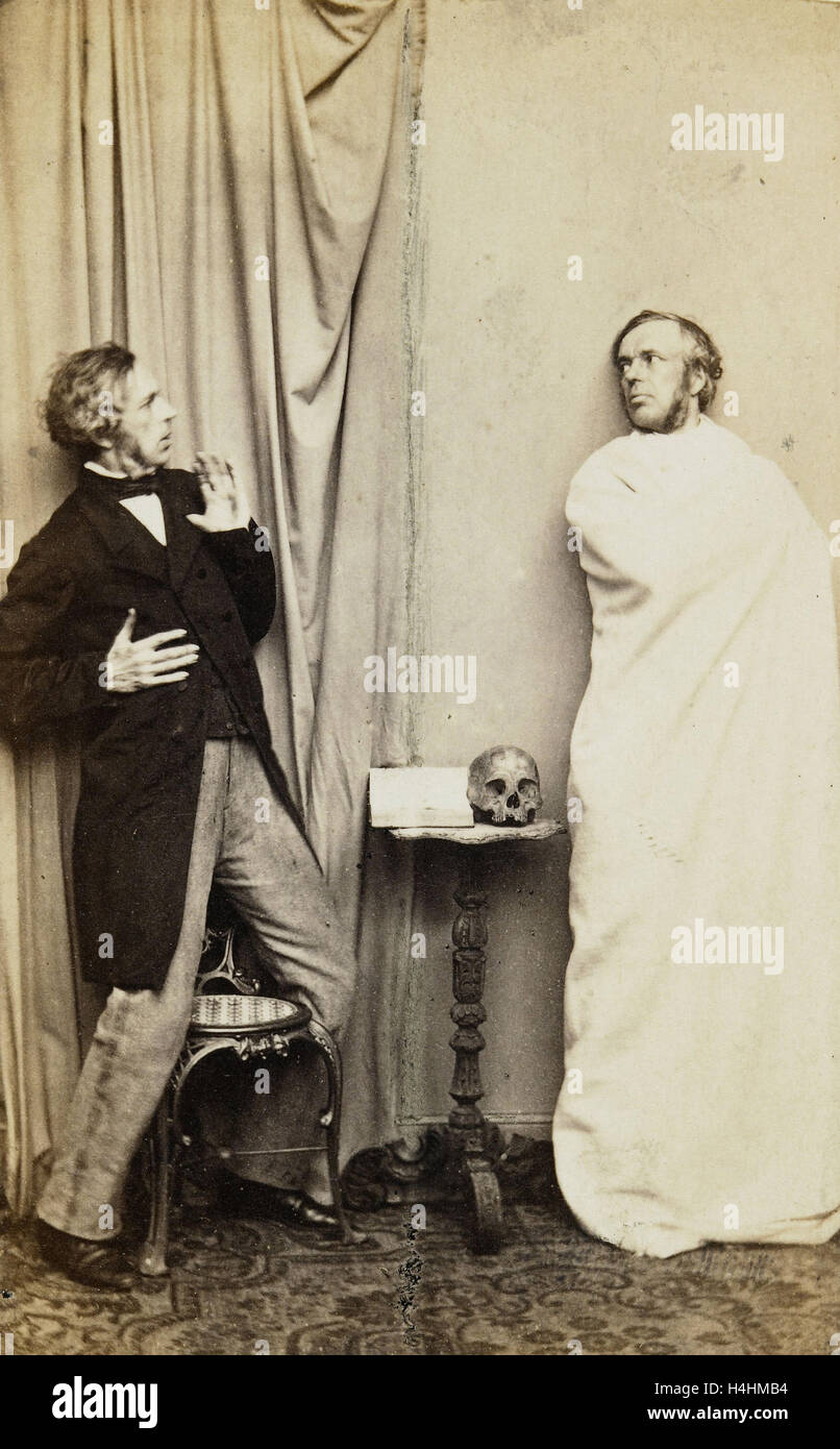 Two standing men acting recoiling sing ghost with skull on the table ...