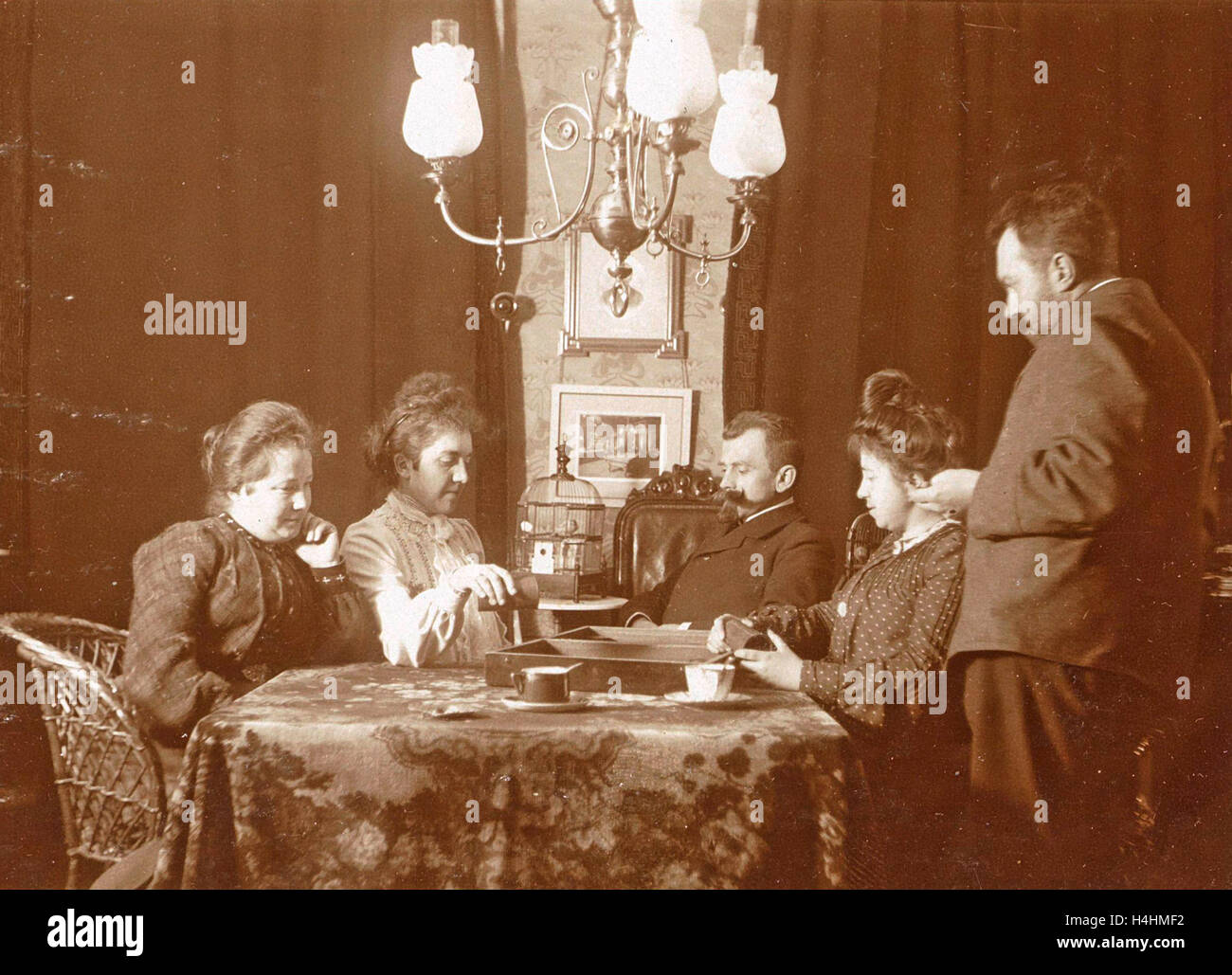 Men and women playing a board game in a living room, Anonymous, c. 1900 ...