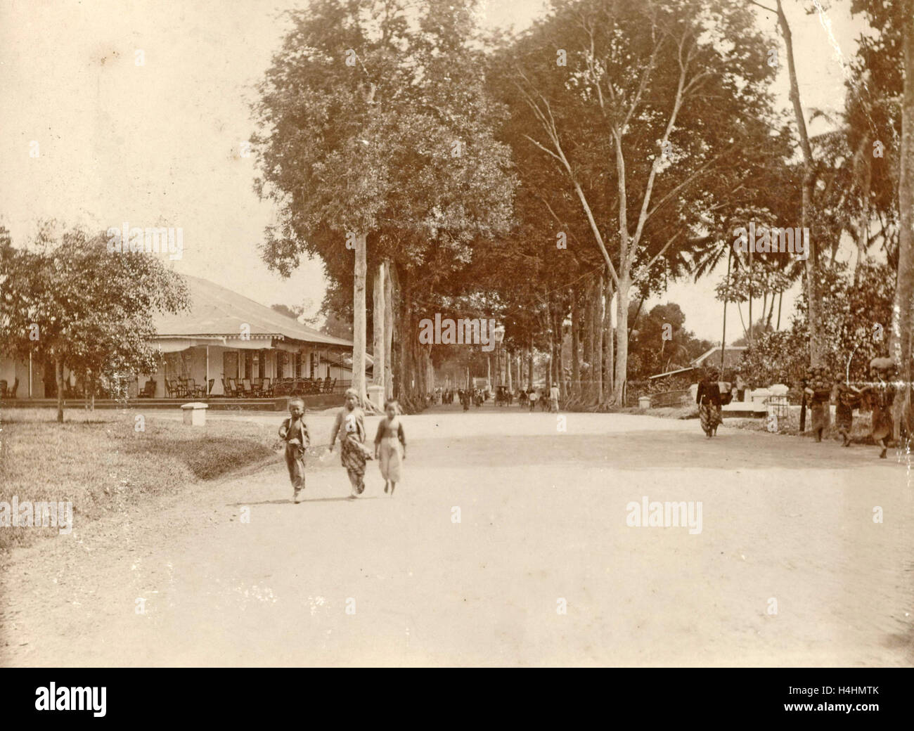 Street scene in the Dutch East Indies with children, porters and ...