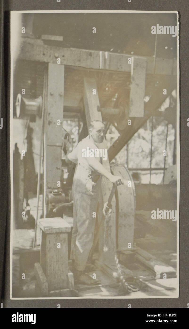 Man operating a machine with a lever, Anonymous Stock Photo - Alamy