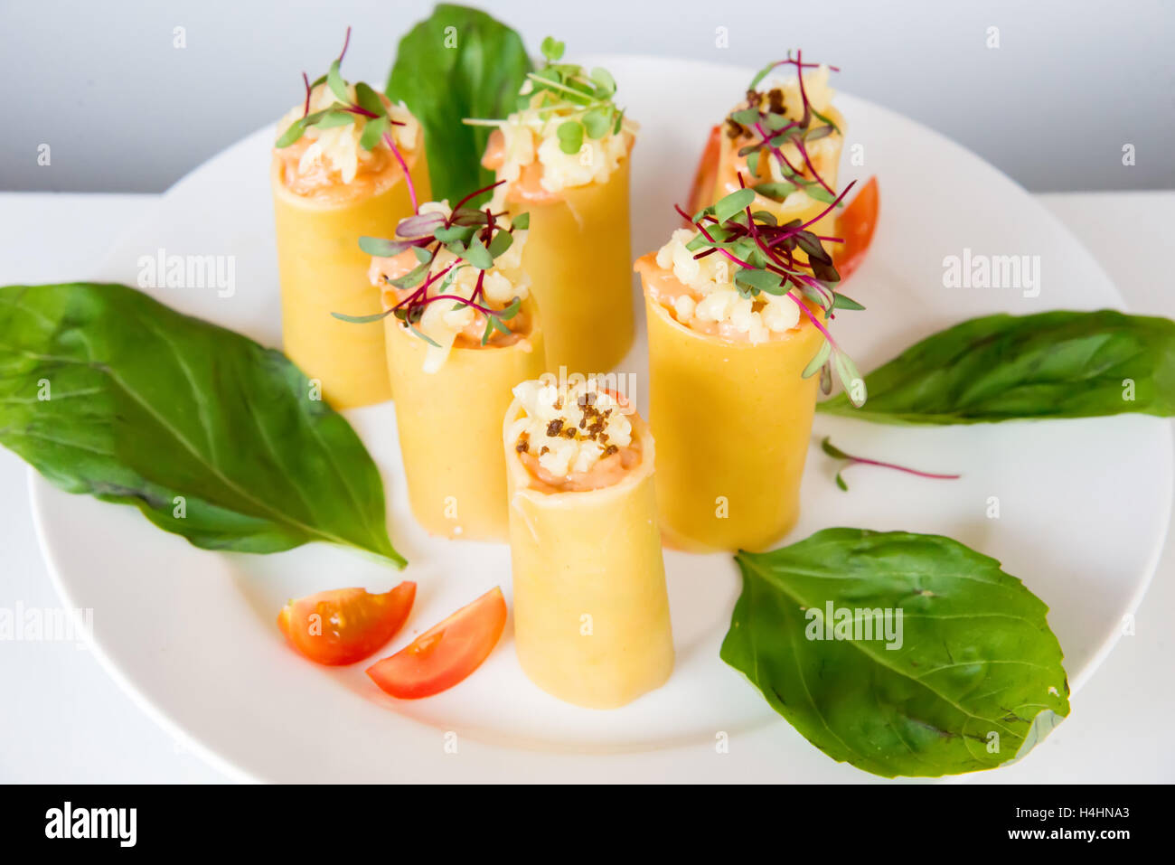 the appetizer - cheese rolls with meat and vegetables Stock Photo - Alamy