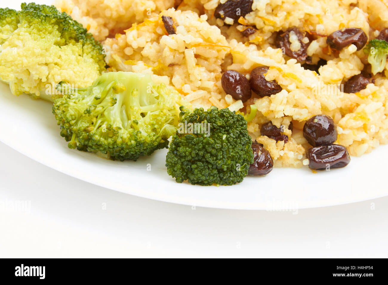 pilaf. boiled rice with raisins on white plate Stock Photo - Alamy
