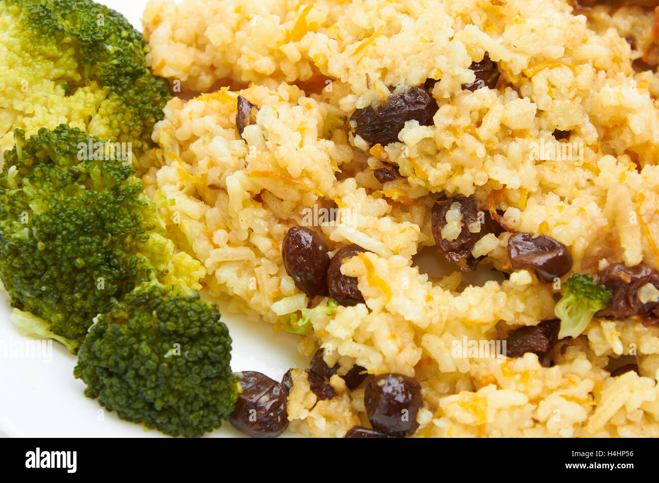 pilaf. boiled rice with raisins on white plate Stock Photo - Alamy
