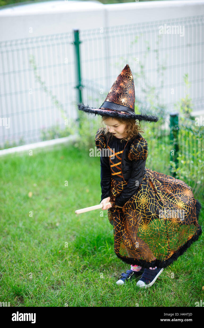 Preparation for Halloween. The girl in a suit of the evil witch ...