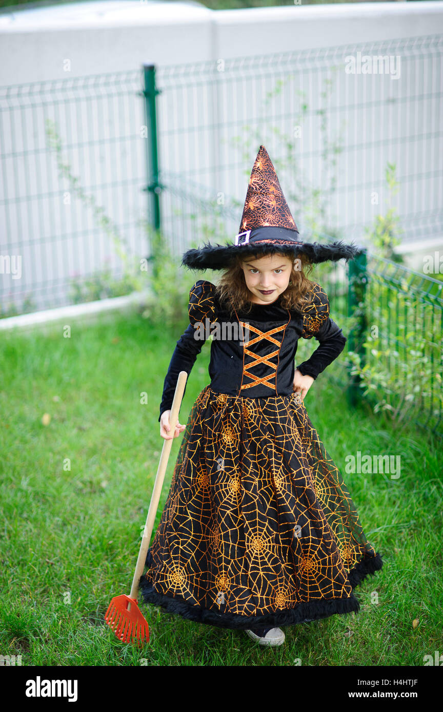 Preparation for Halloween. The girl in a suit of the evil witch cleans ...