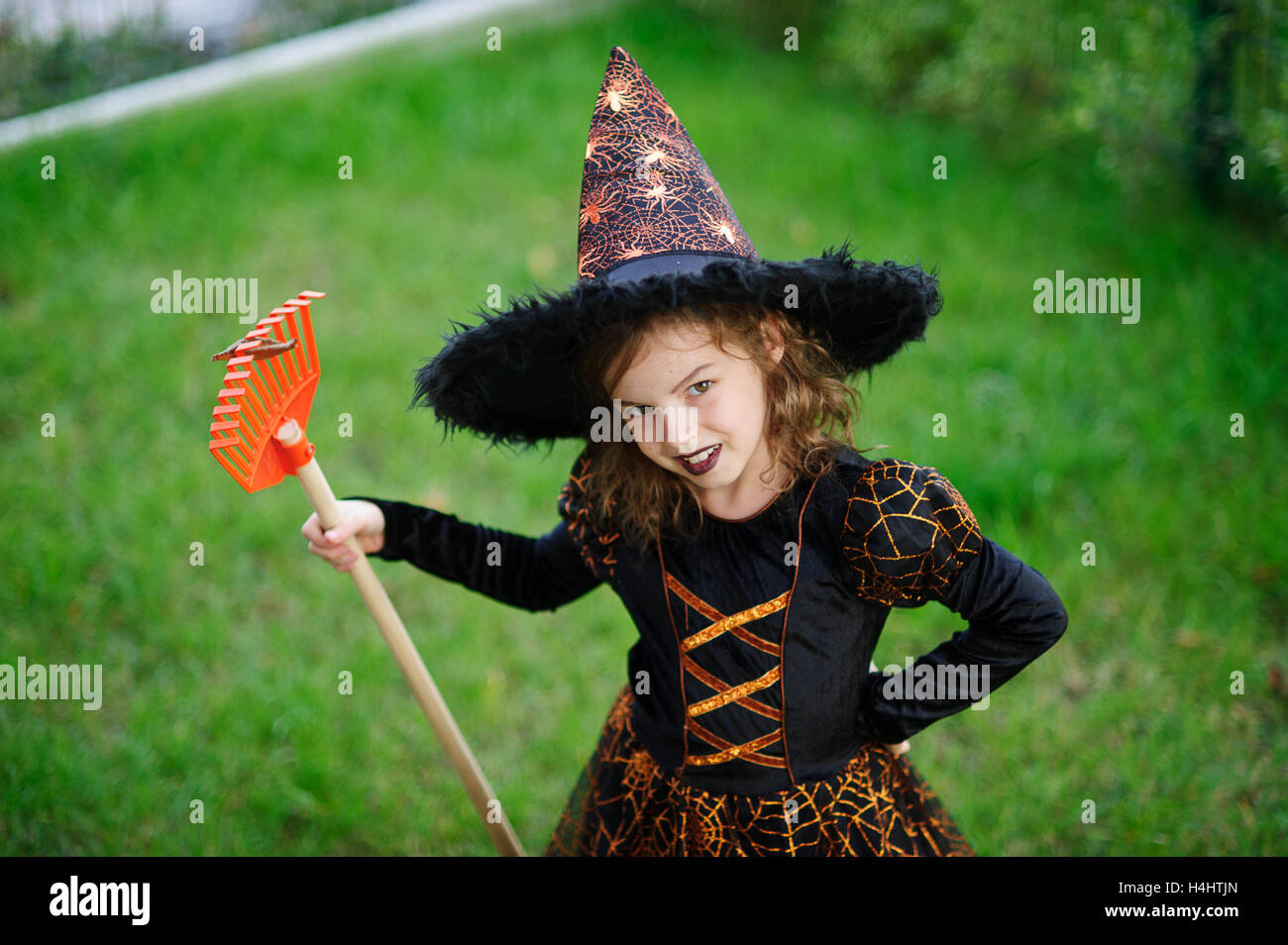 Preparation for Halloween. The girl in a suit of the evil witch cleans ...