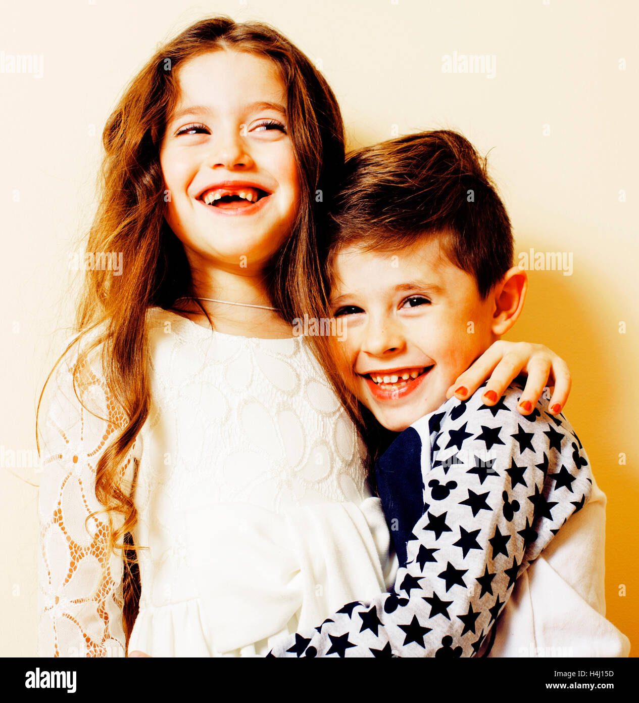 little cute boy and girl hugging playing on white background, ha Stock Photo - Alamy