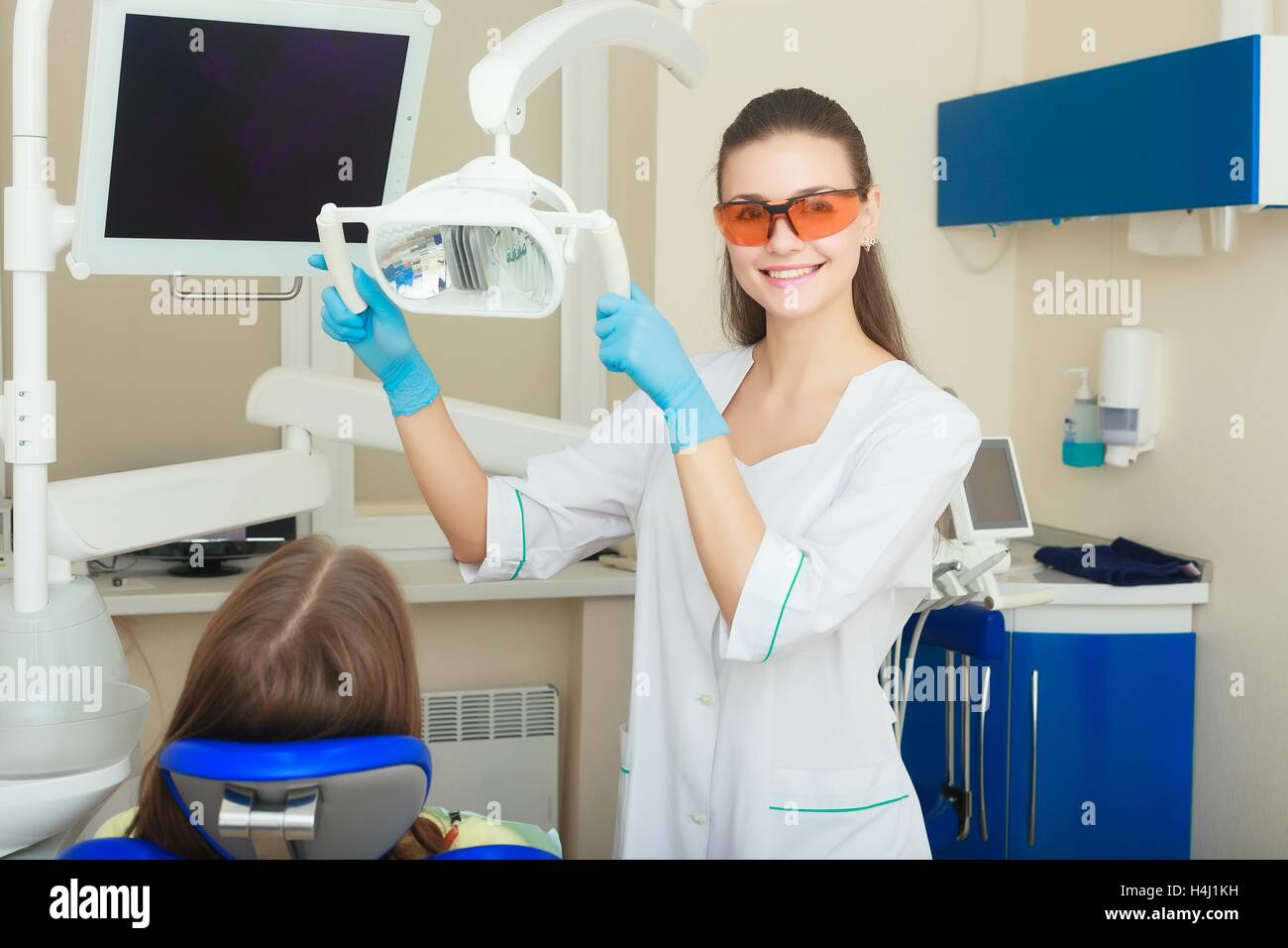 attractive woman dentist with girl patient Stock Photo - Alamy