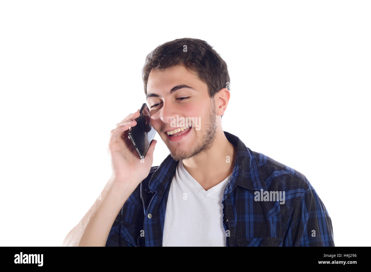 Portrait of attractive young man talking on his phone. Isolated white ...