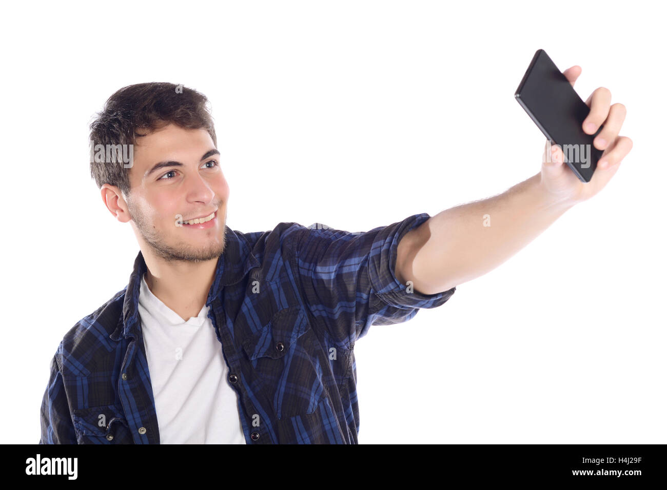 Portrait of attractive young man taking a selfie with his smartphone. Isolated white background ...