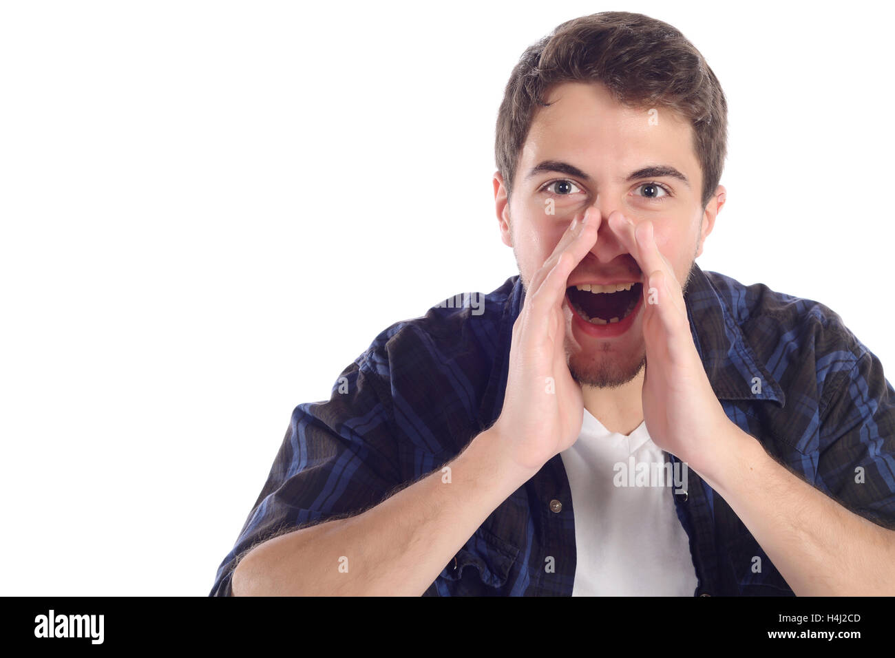 Attractive young man shouting with hands near his mouth. Isolated white ...