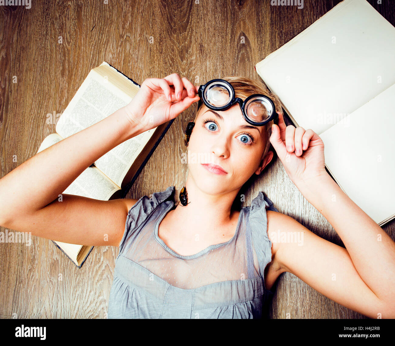 portrait of crazy student girl in glasses with books and cockroa Stock ...